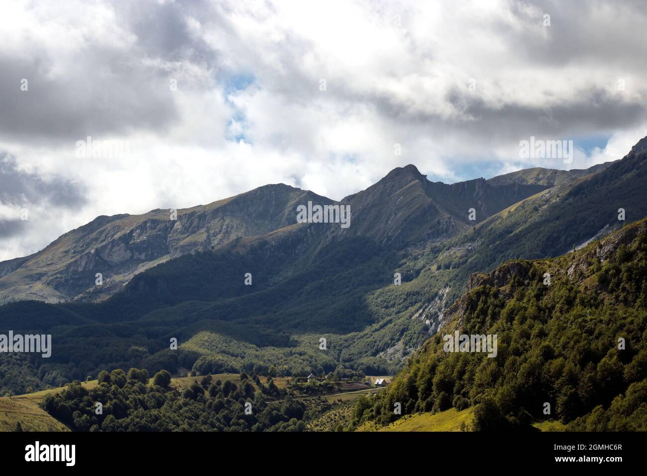 A low angle shot of mountainous landscape with layers of peaks seen ...