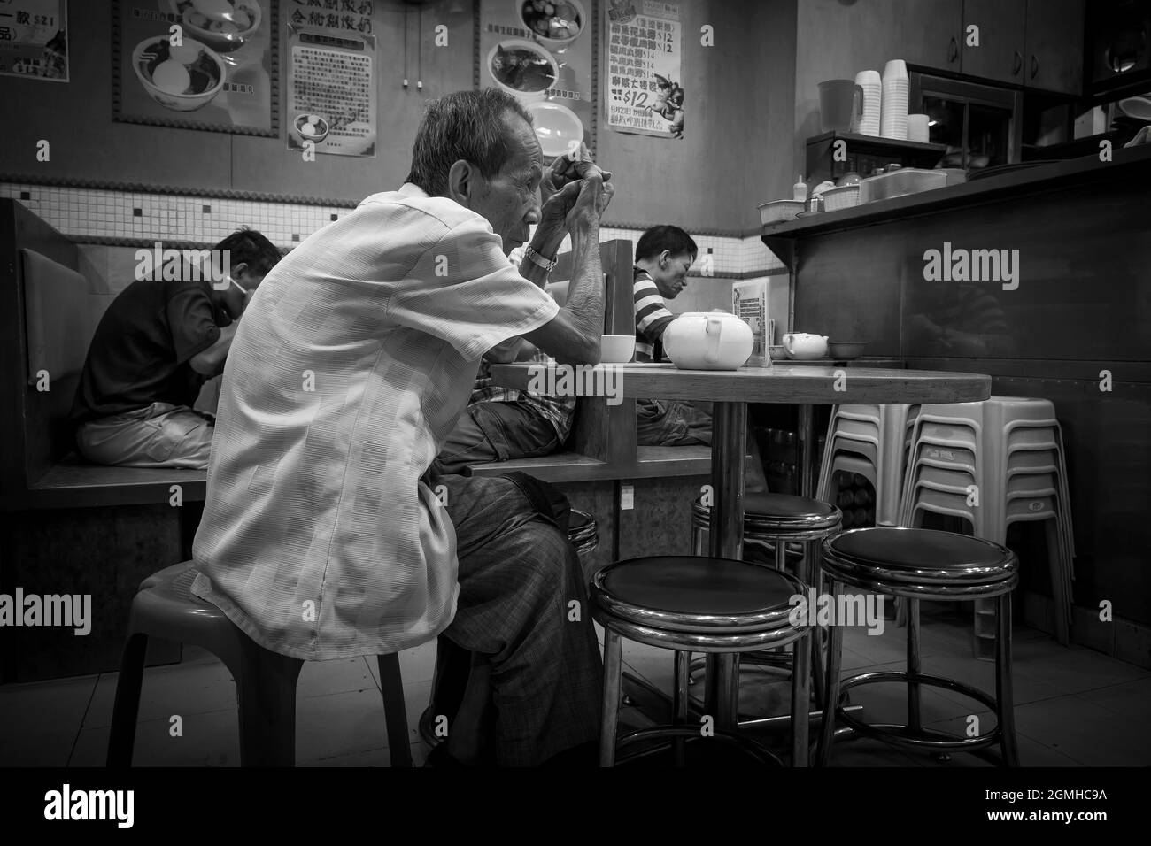 An old man waits for his food in a restaurant in Yuen Long, New ...