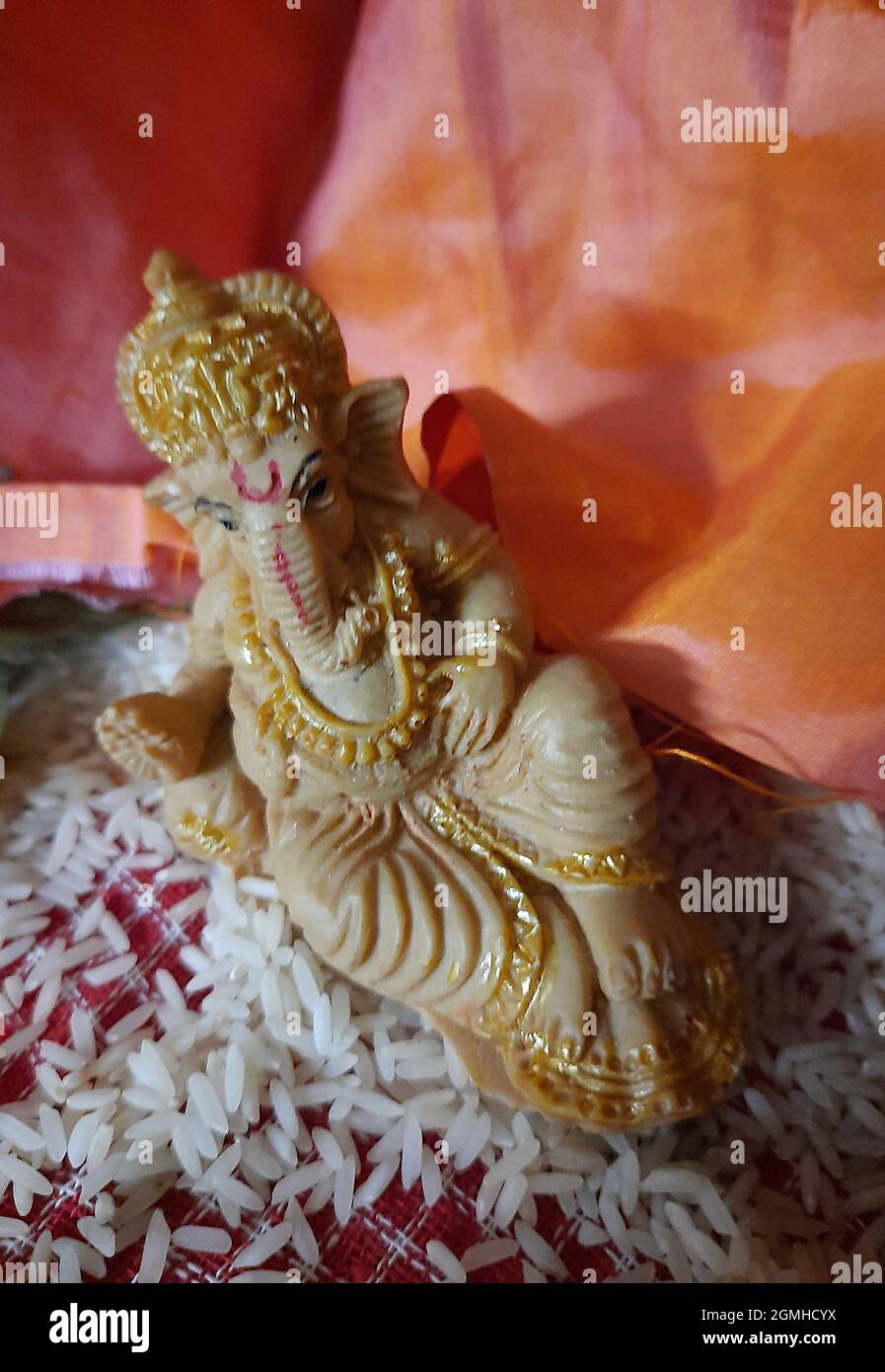 Close-up of ceramic idol of Ganesha in reclining position Stock Photo ...