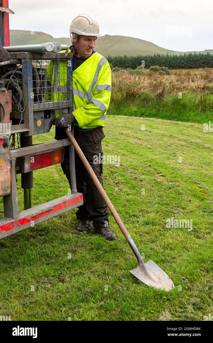 Engineer with long spade installing fiber optic broadband Stock Photo ...