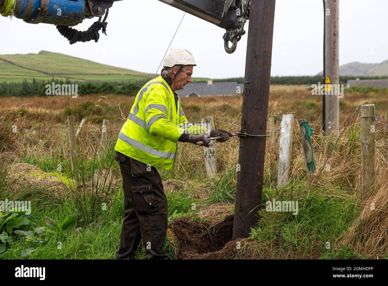 installing a pole for an overhead fiber Optic Broadband Cable Stock ...
