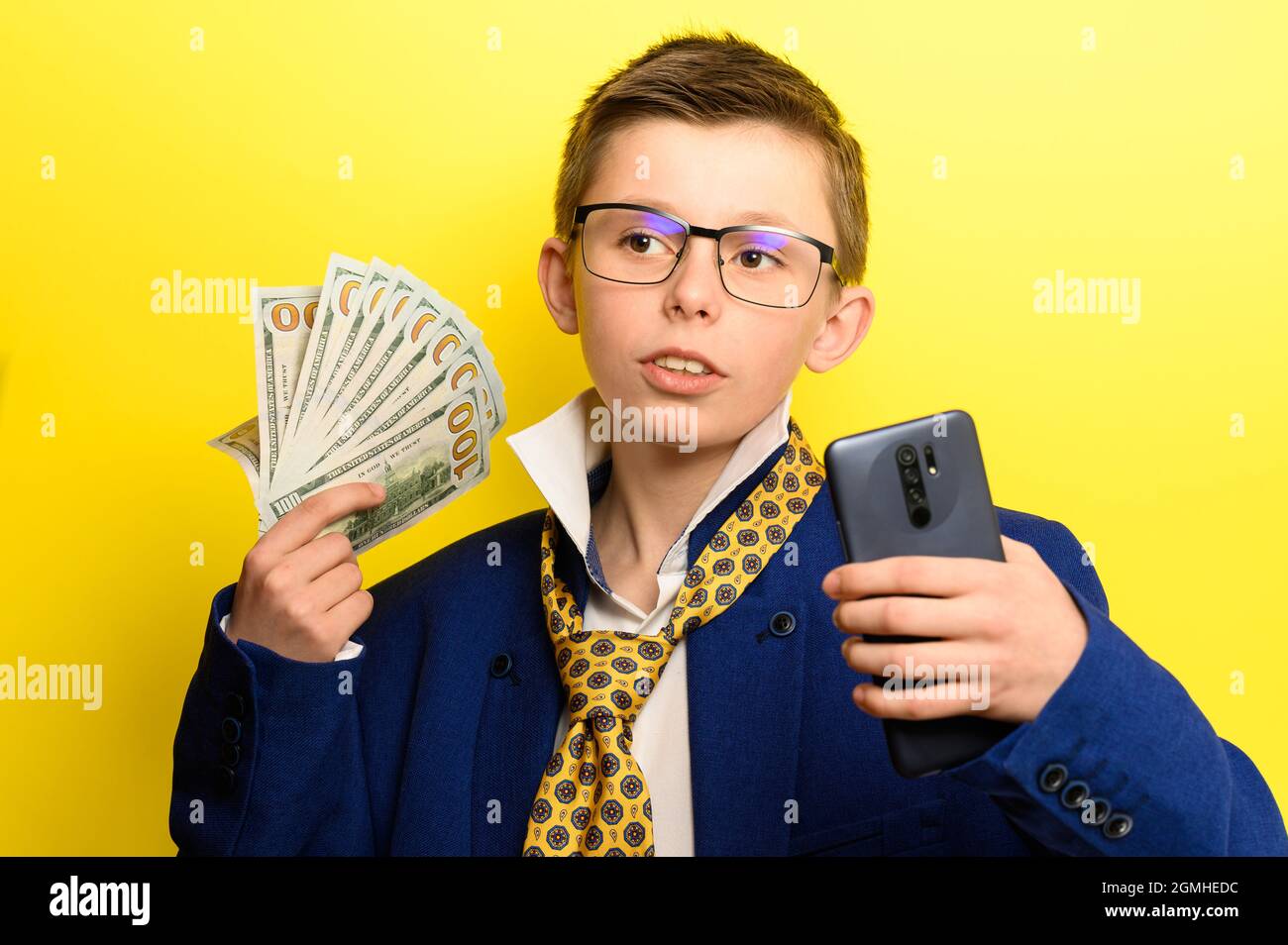 Successful and rich child taking a selfie with money, portrait of a boy ...