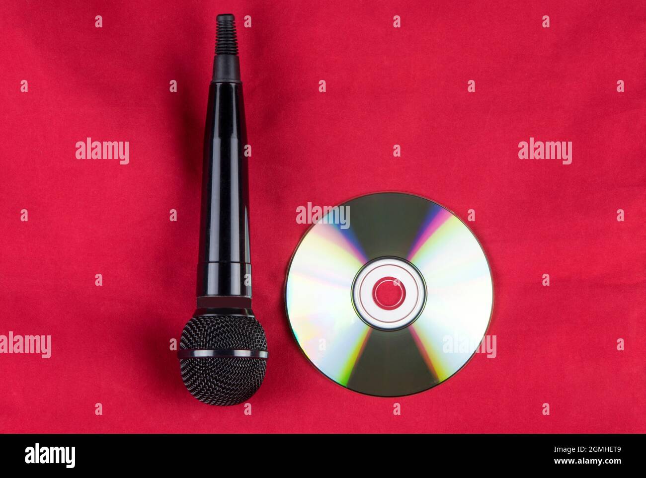 Compact disc and microphone against a red background Stock Photo - Alamy