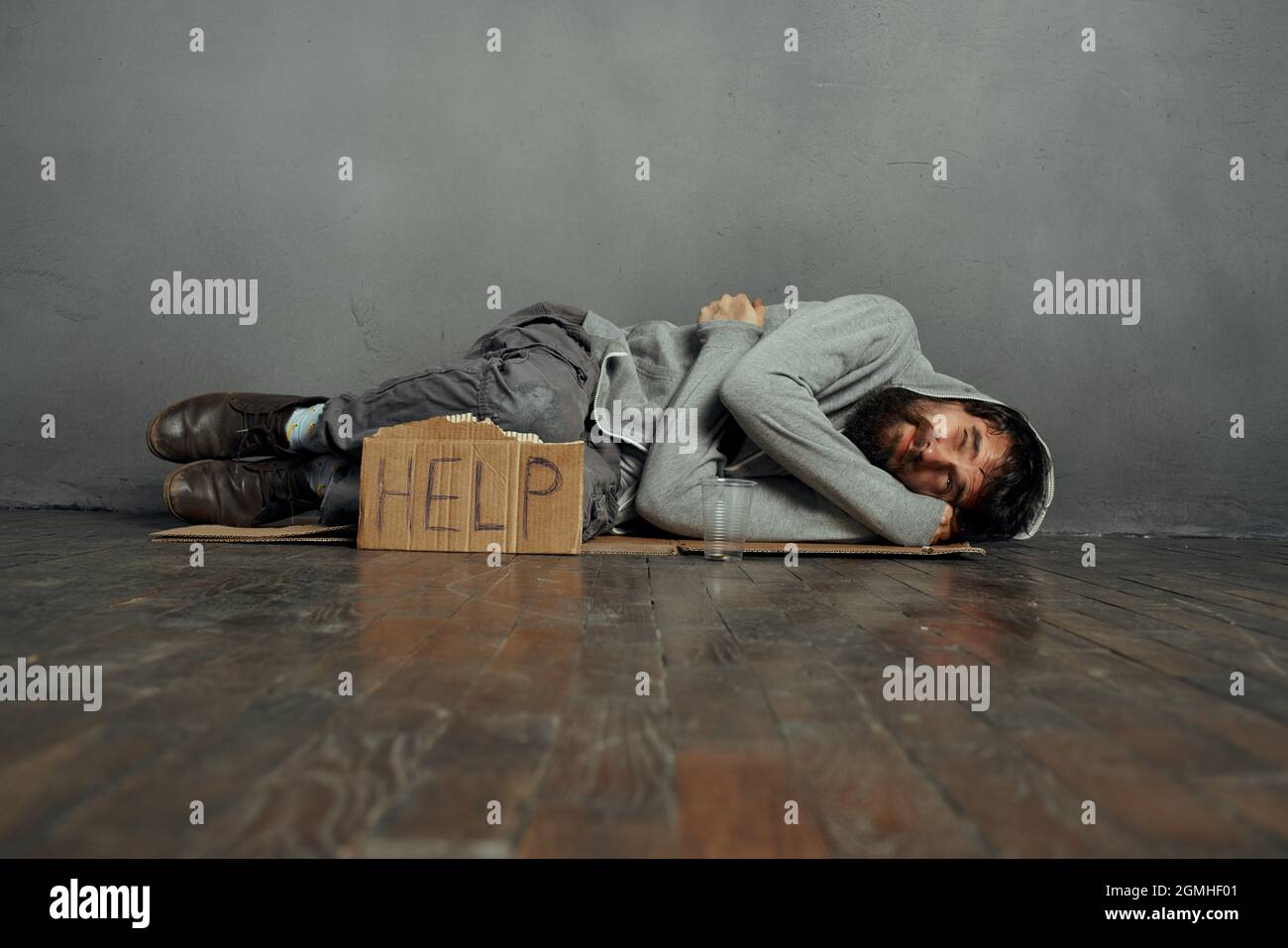 beggar man lying on the floor homeless depression help money problems ...