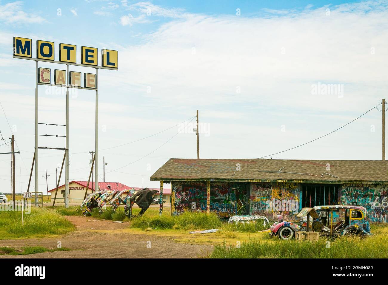 painted Volkswagen Beetles half buried at an angle at Slug Bug Ranch ...