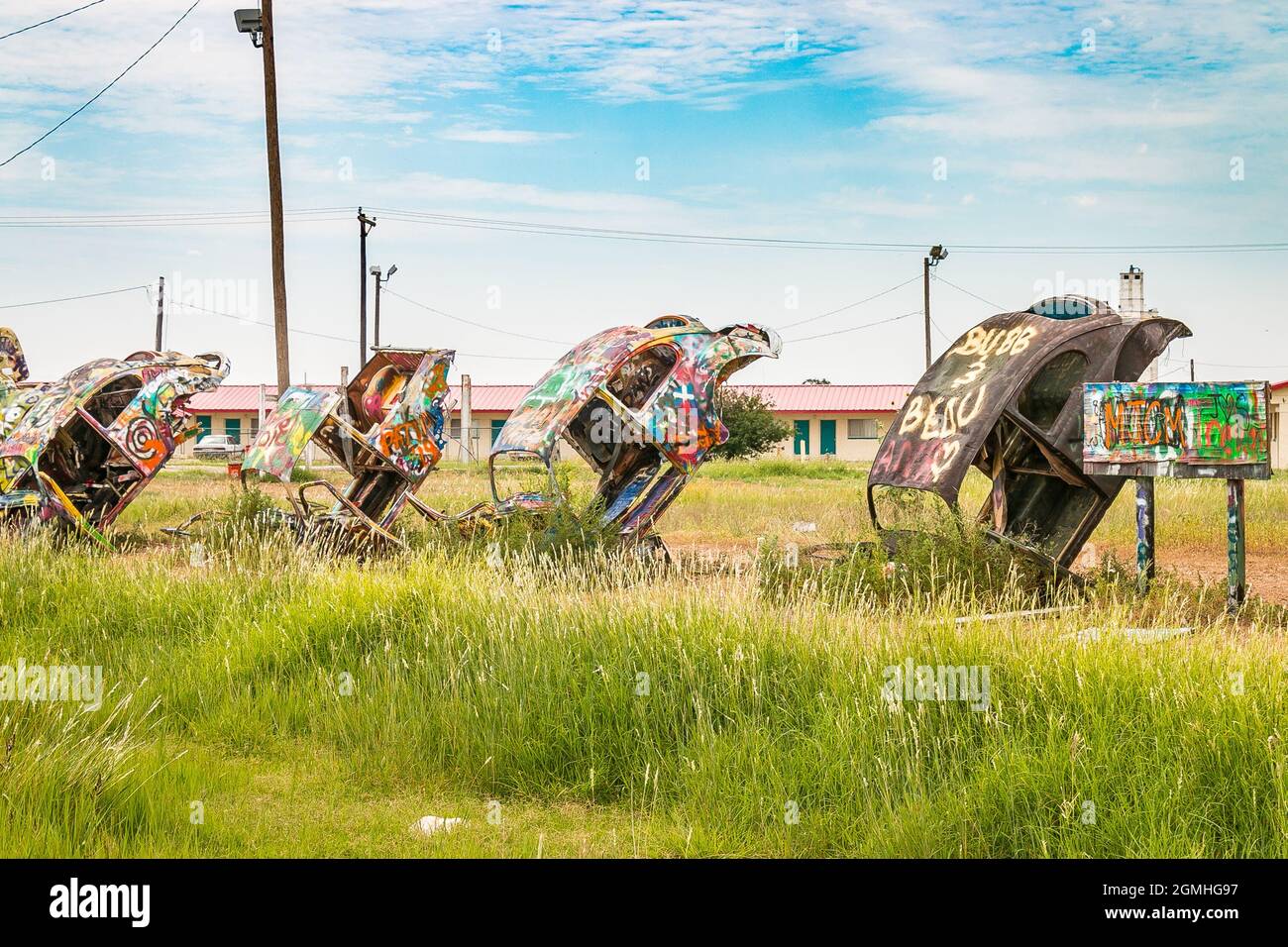painted Volkswagen Beetles half buried at an angle at Slug Bug Ranch ...
