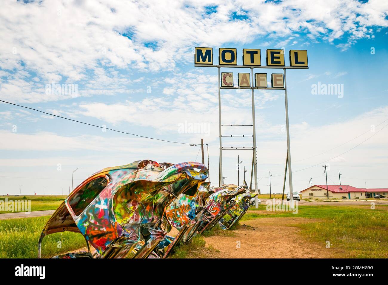 painted Volkswagen Beetles half buried at an angle at Slug Bug Ranch ...