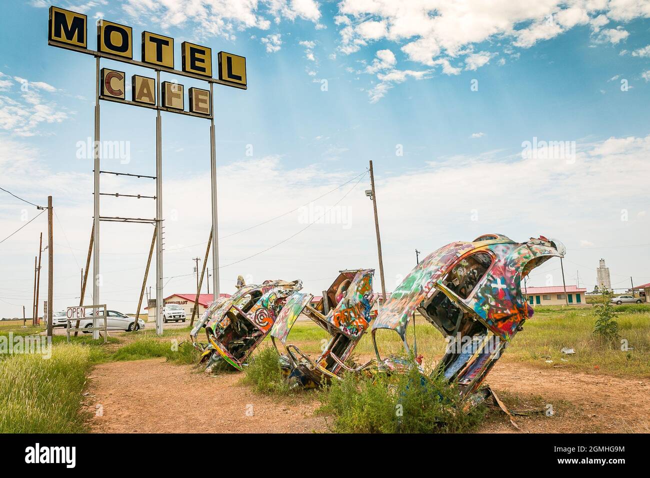 painted Volkswagen Beetles half buried at an angle at Slug Bug Ranch ...