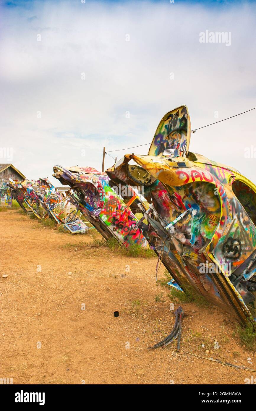 painted Volkswagen Beetles half buried at an angle at Slug Bug Ranch ...