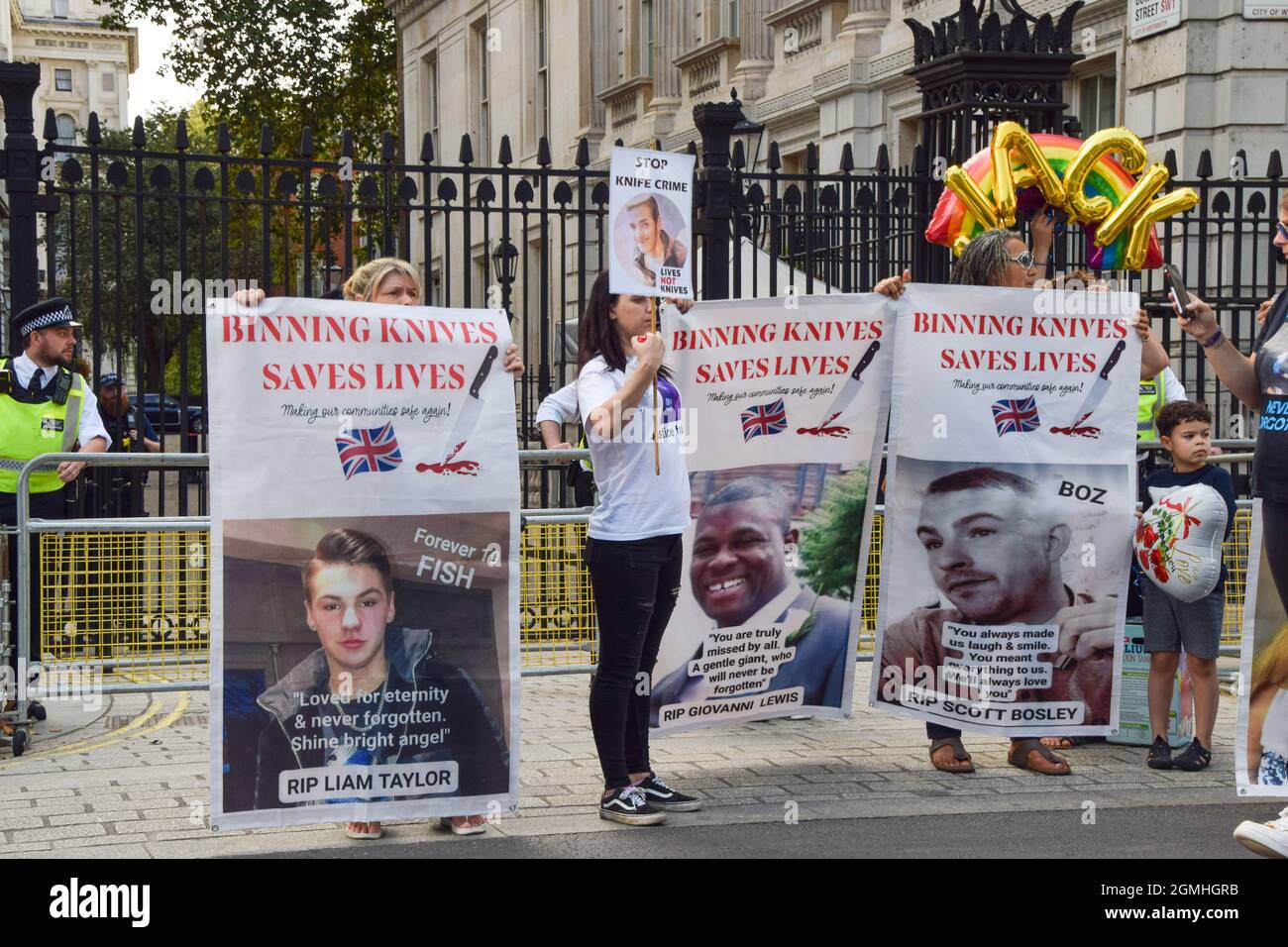 London, United Kingdom. 18th September 2021. Activists hold pictures of ...