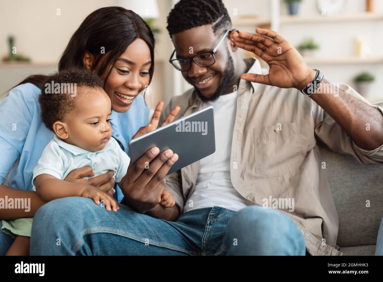 Black family having video call using tablet waving hands Stock Photo ...