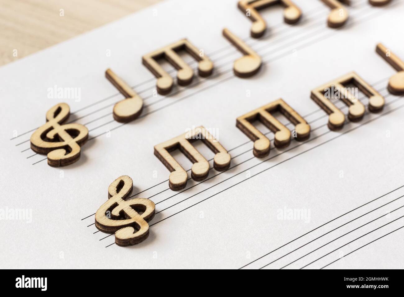 Wooden musical notes lying on the table. Diagonal with a shallow depth ...