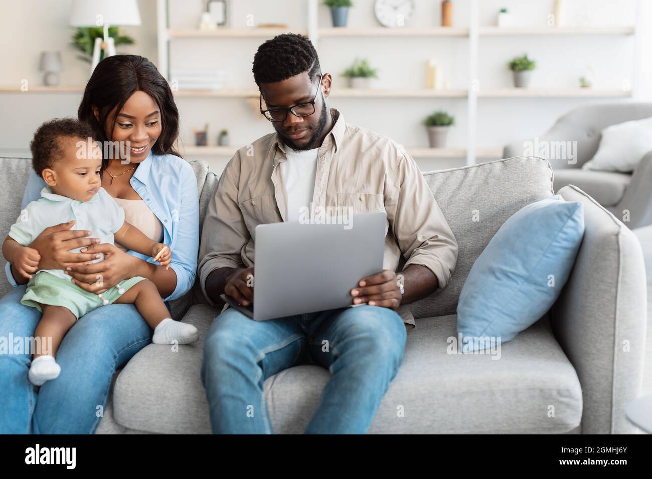 African american family using computer with baby at home Stock Photo ...