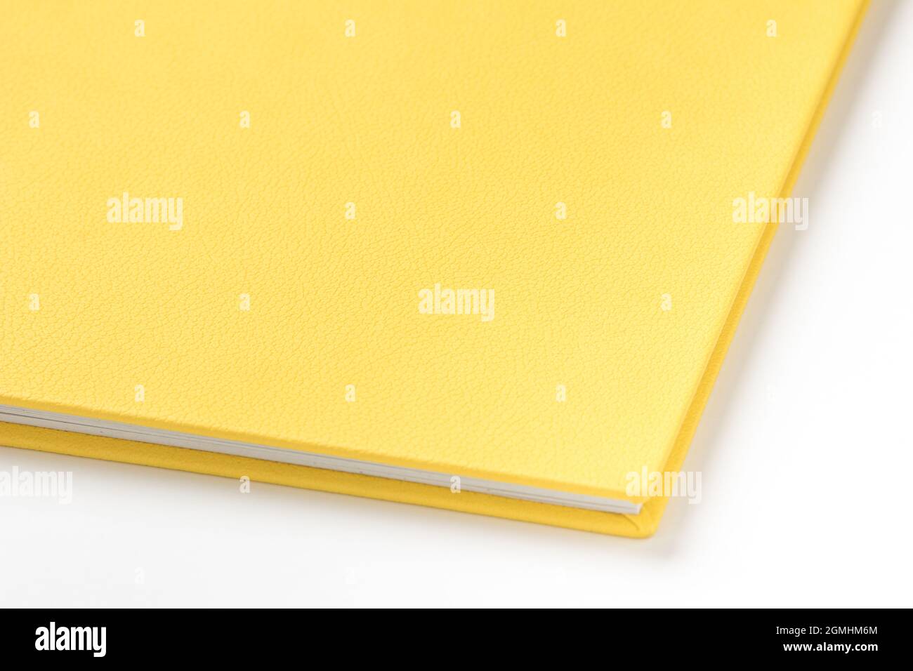 Yellow hard cover book on white background Stock Photo - Alamy