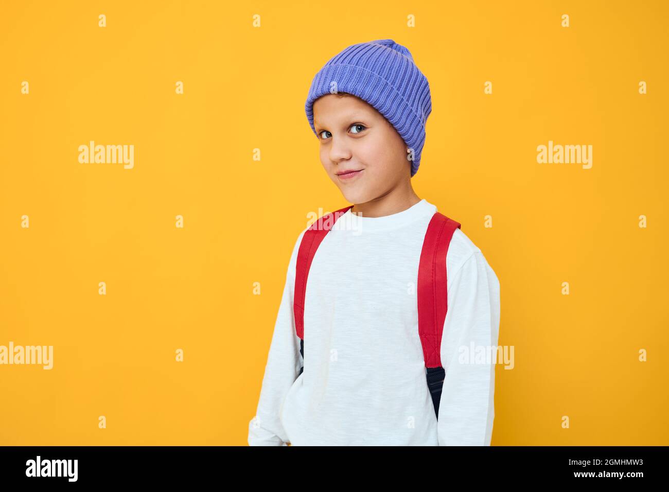 boy wearing blue hat school backpack posing yellow background Stock ...