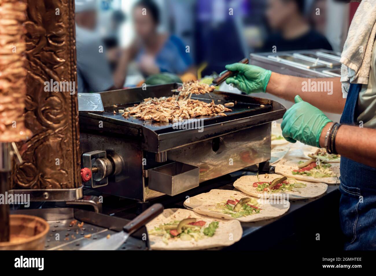 Preparation of Turkish shawarma. the cook's hands in rubber gloves ...