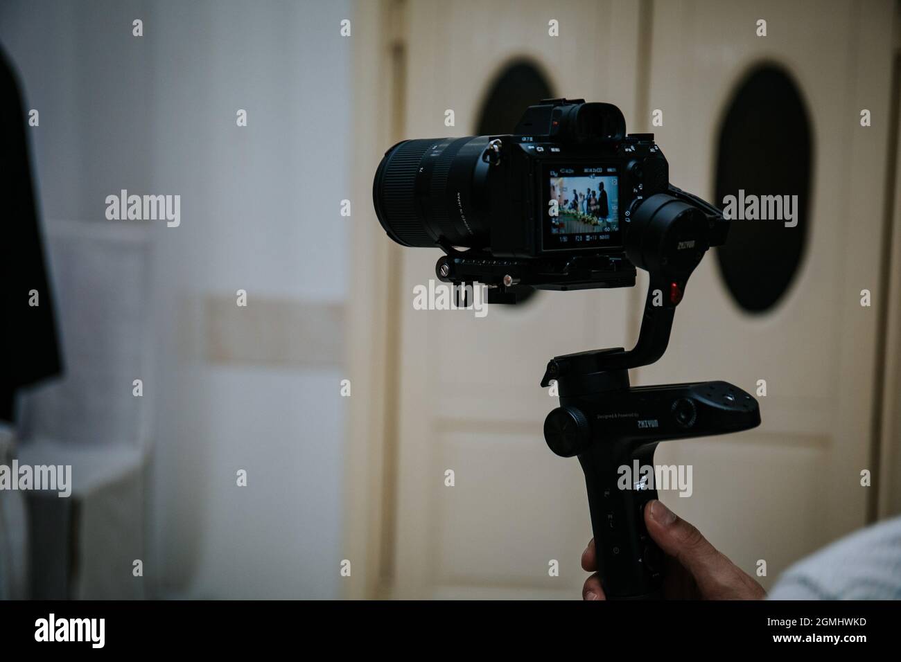 A cameraman shooting a wedding ceremony with a video camera Stock Photo ...