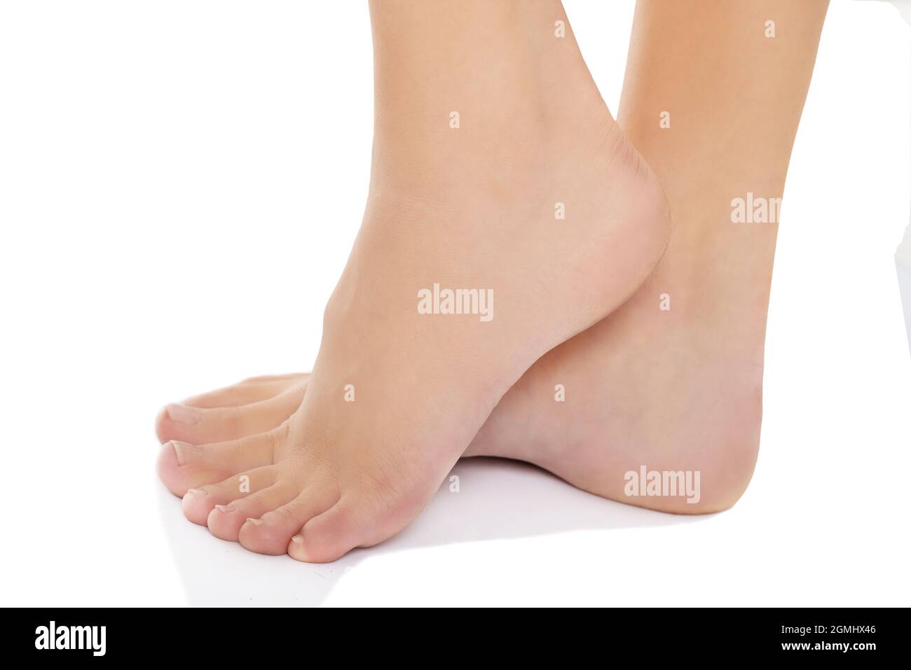 Beautiful female feet on a white background Stock Photo - Alamy