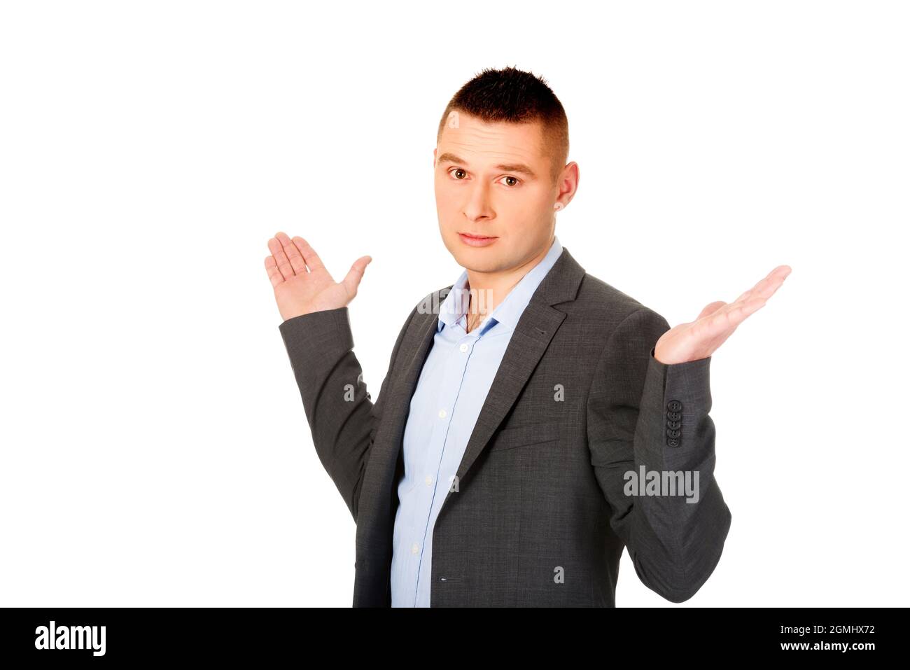 A businessman showing "I don't know" gesture on a white background ...