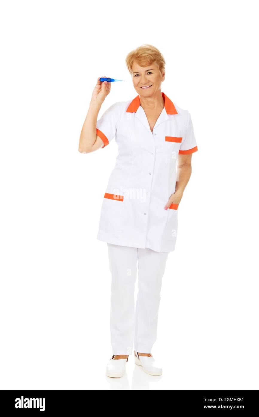 A senior female doctor wearing a white and orange uniform isolated and ...