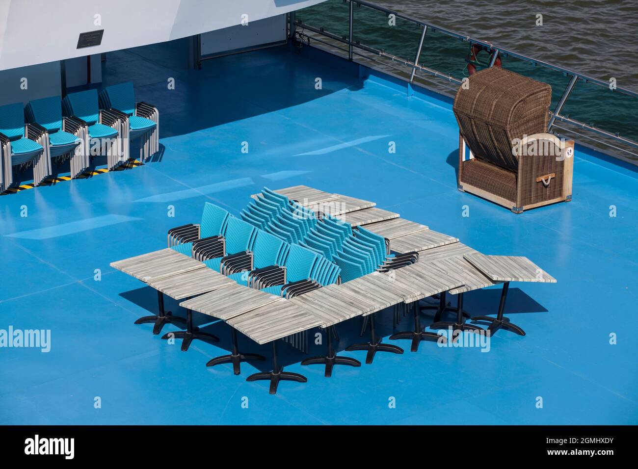 stacked chairs and tables on a ship of the cruise company Koeln ...