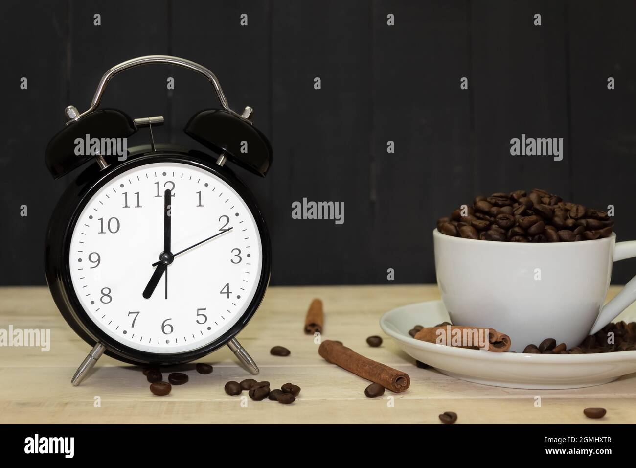 An old alarm clock points to 7.00 and the background has space for text ...