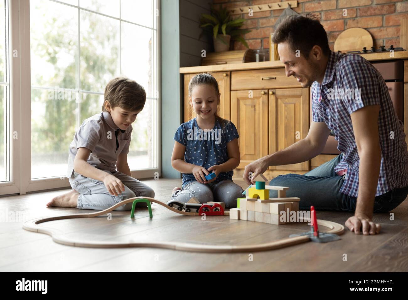 Joyful adorable little kids playing toys with father Stock Photo - Alamy