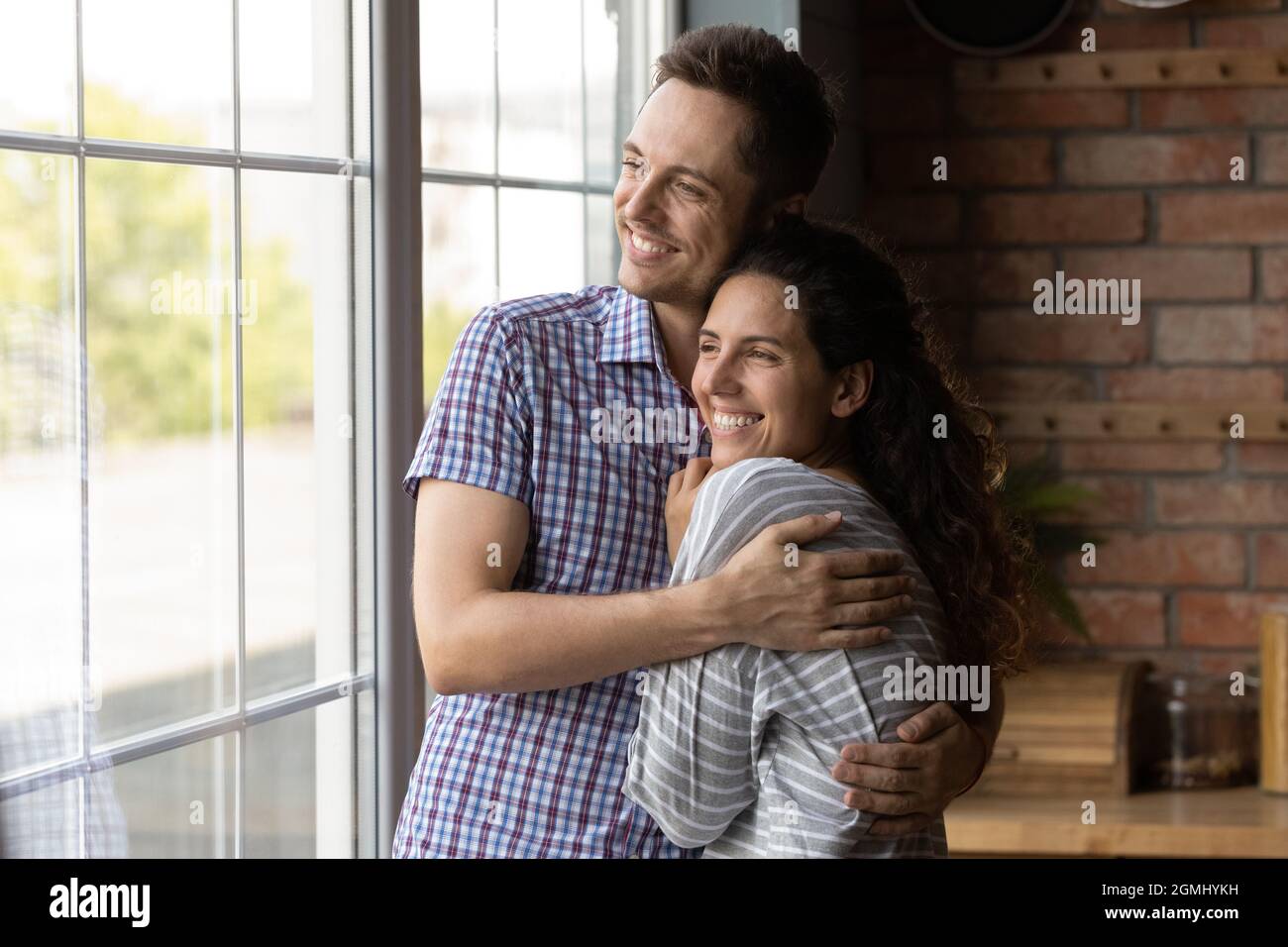 Dreamy loving young couple visualizing future together at home Stock ...