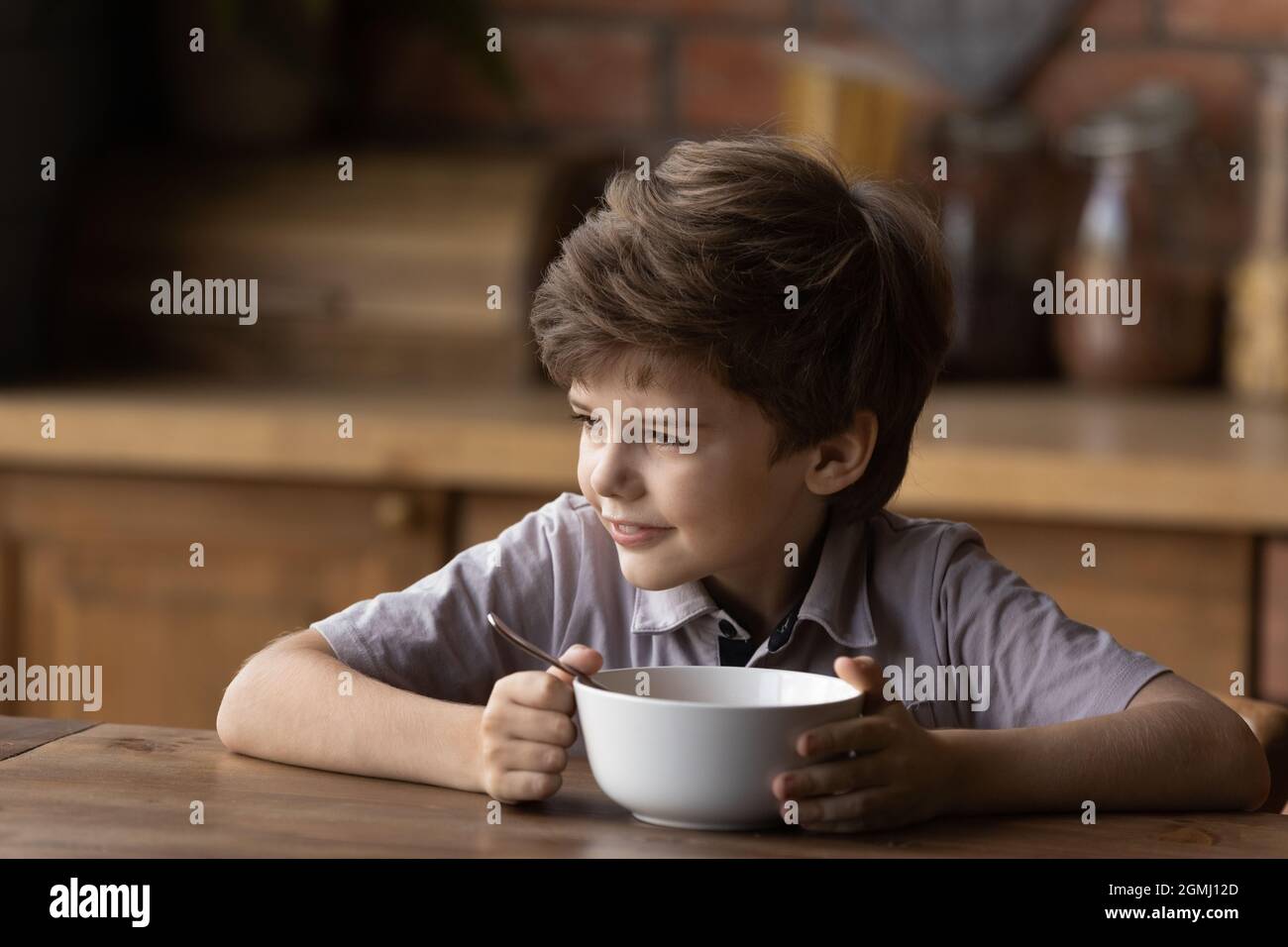 Dreamy smiling little child boy eating fast breakfast Stock Photo - Alamy