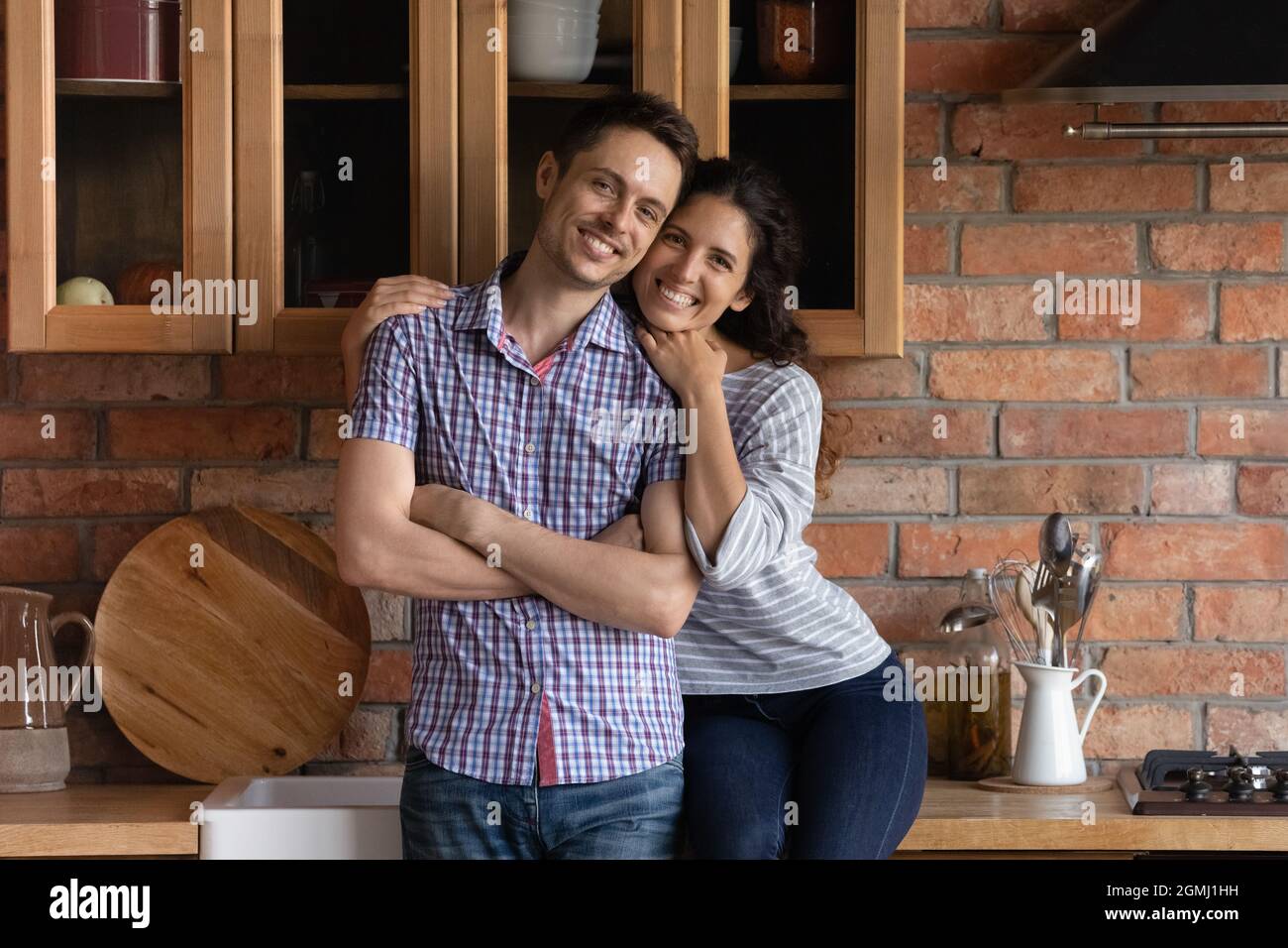 Portrait of smiling bonding millennial hispanic couple posing in ...