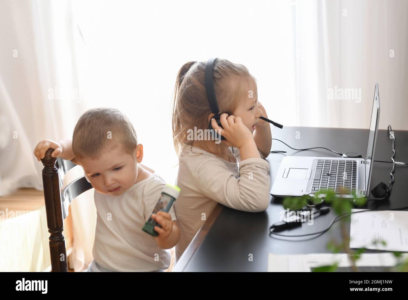 Little kids play with computer of parents Stock Photo - Alamy