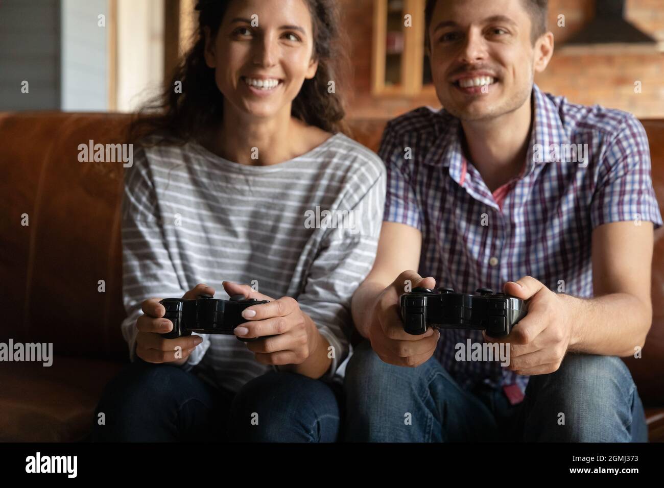 Happy bonding loving married couple playing video games Stock Photo - Alamy
