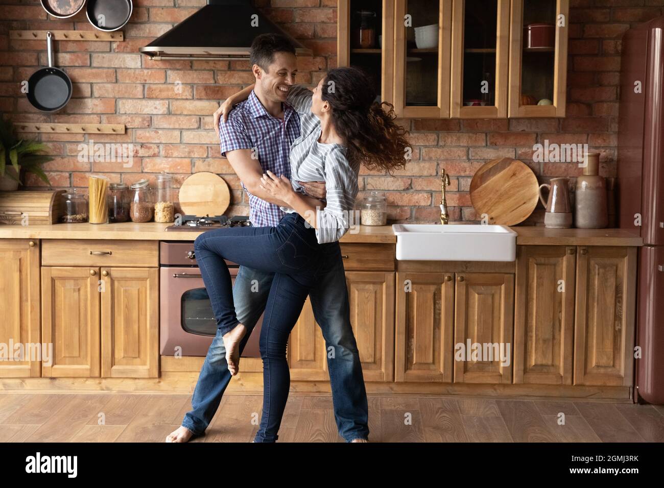 Happy romantic young couple dancing in renovated kitchen Stock Photo ...