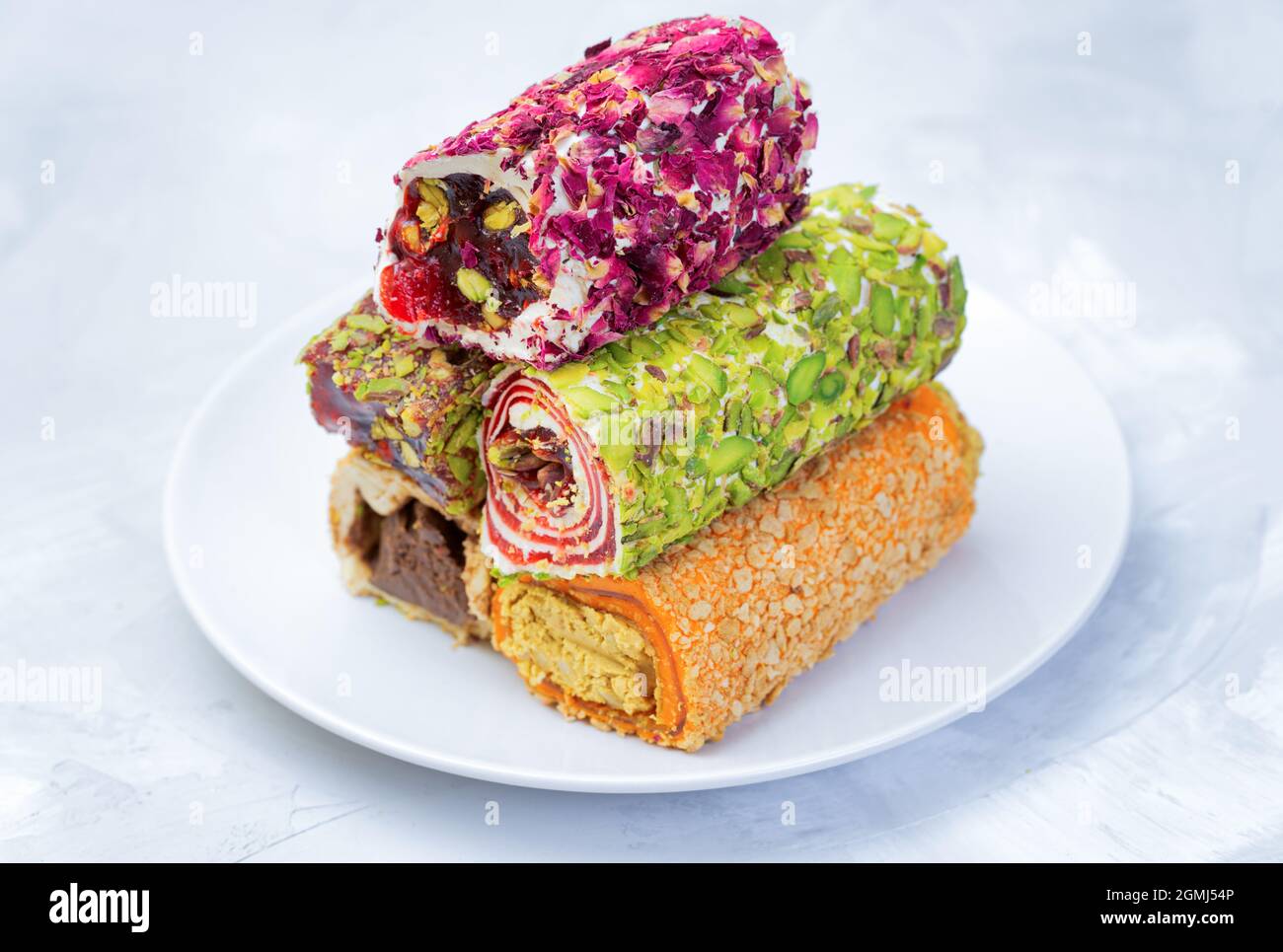 White plate with assorted turkish delight on a concrete table ...
