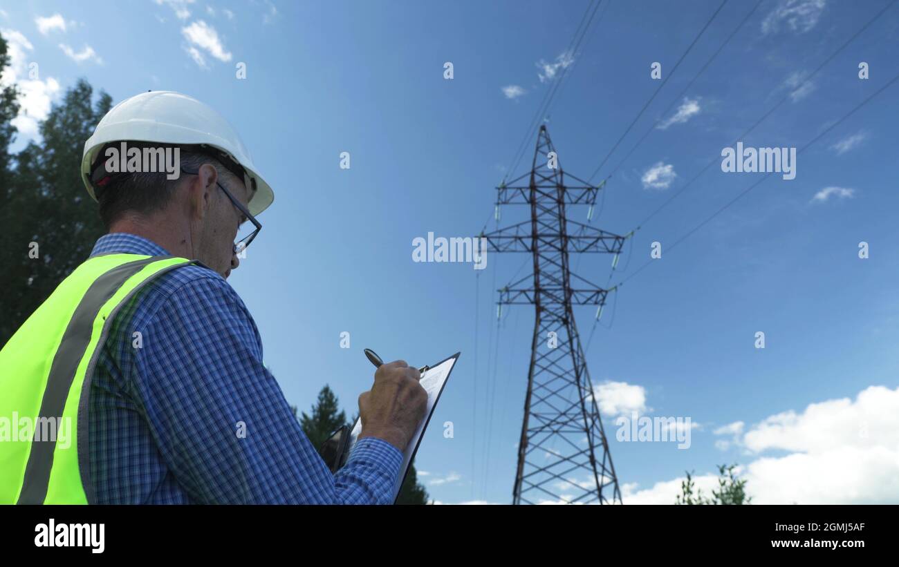 Electrical engineer works by inspecting power lines Stock Photo - Alamy