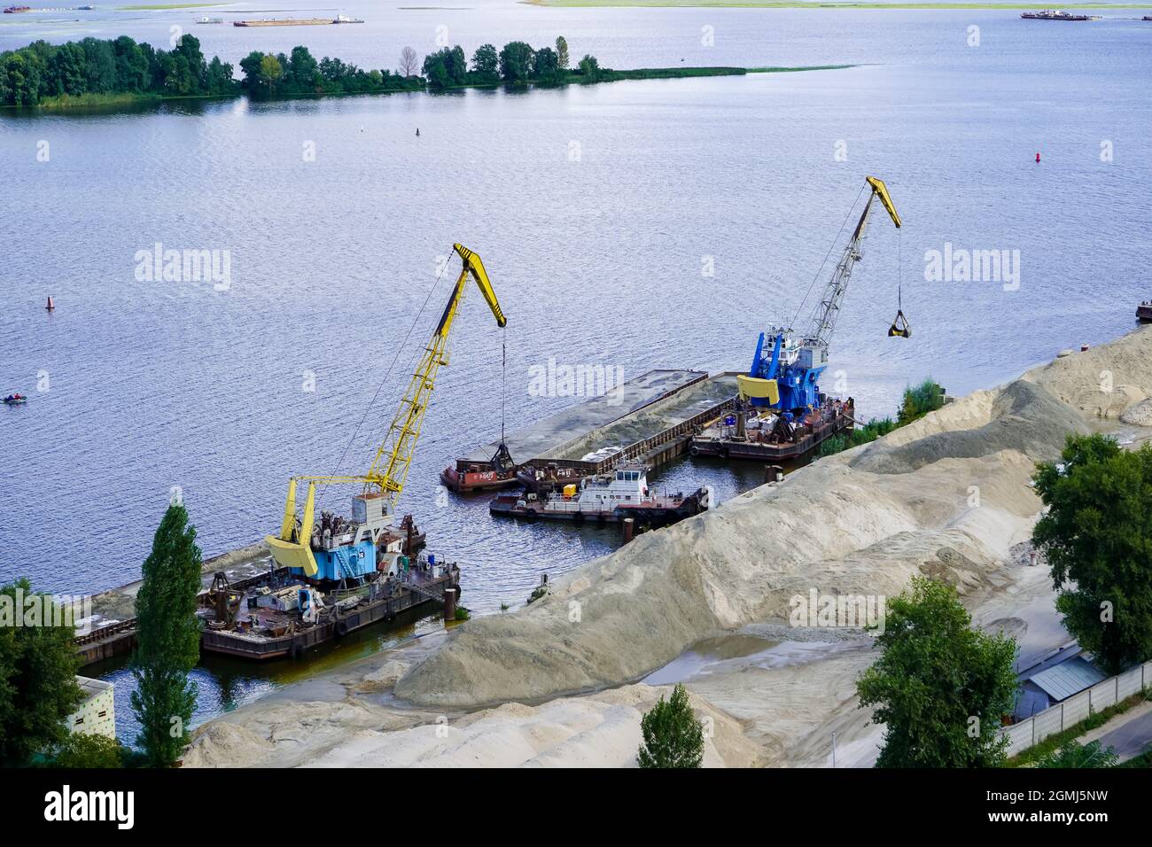 River port . Loading sand onto a barge. Drainage of the banks of the ...
