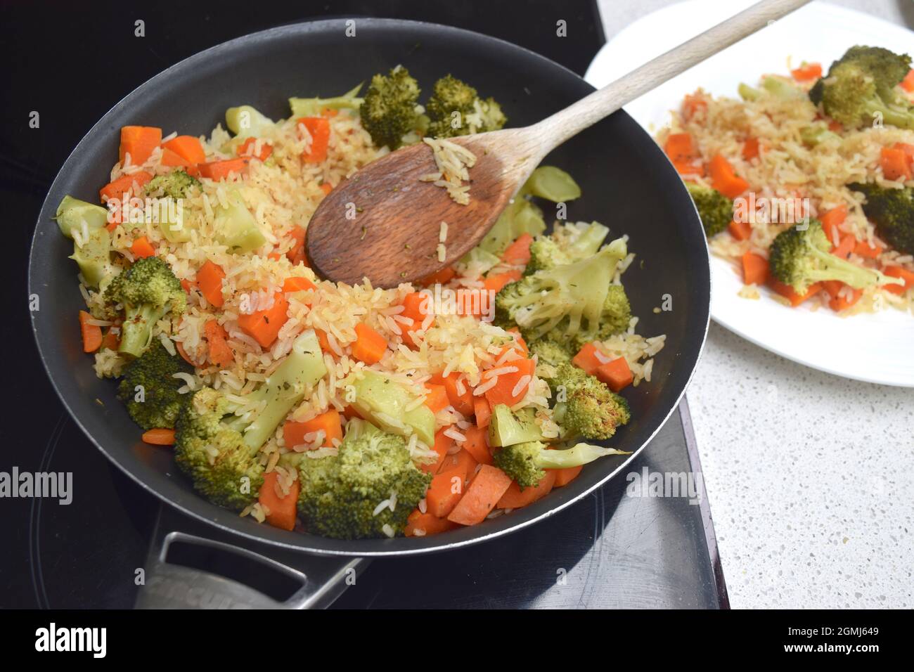 Vegetarian dish with cooked rice, broccoli and carrots Stock Photo - Alamy