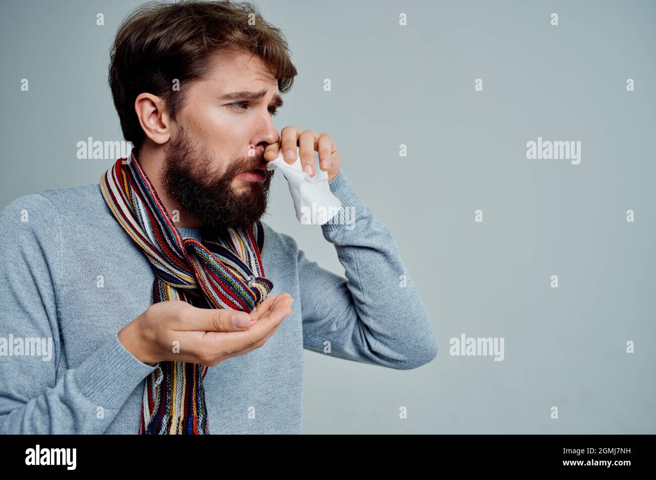 sick man with a scarf around his neck flu health problems light ...
