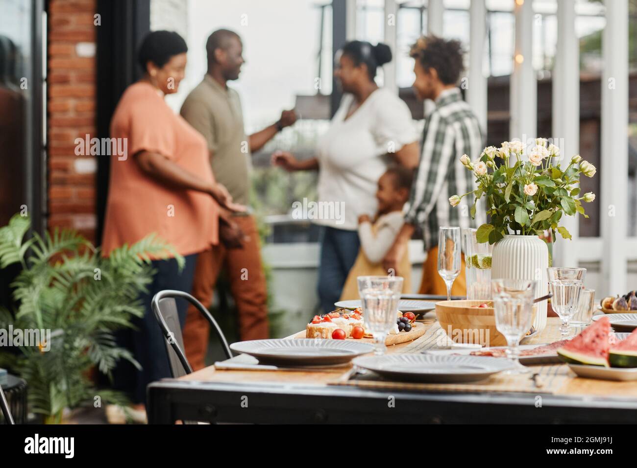 Portrait of happy multi-generational family chatting during dinner ...