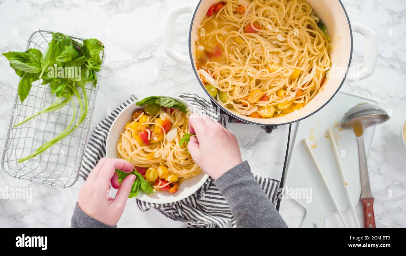 Flat lay. Step by step. Serving a one-pot pasta into a white pasta ...