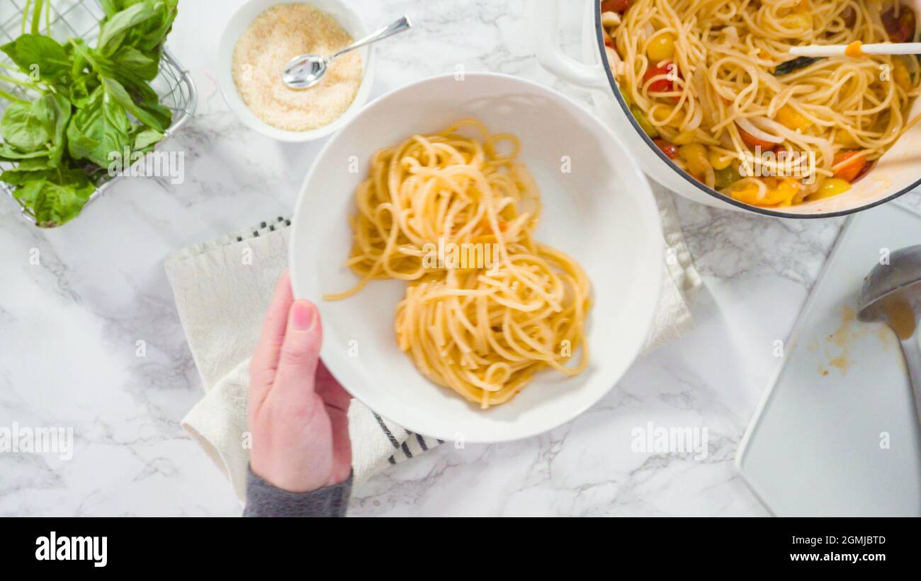 Flat lay. Step by step. Serving a one-pot pasta into a white pasta ...