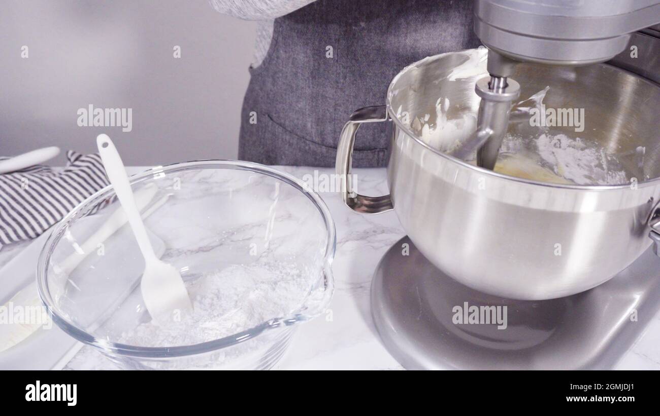 Step by step. Mixing ingredients in a standing kitchen mixer to prepare ...