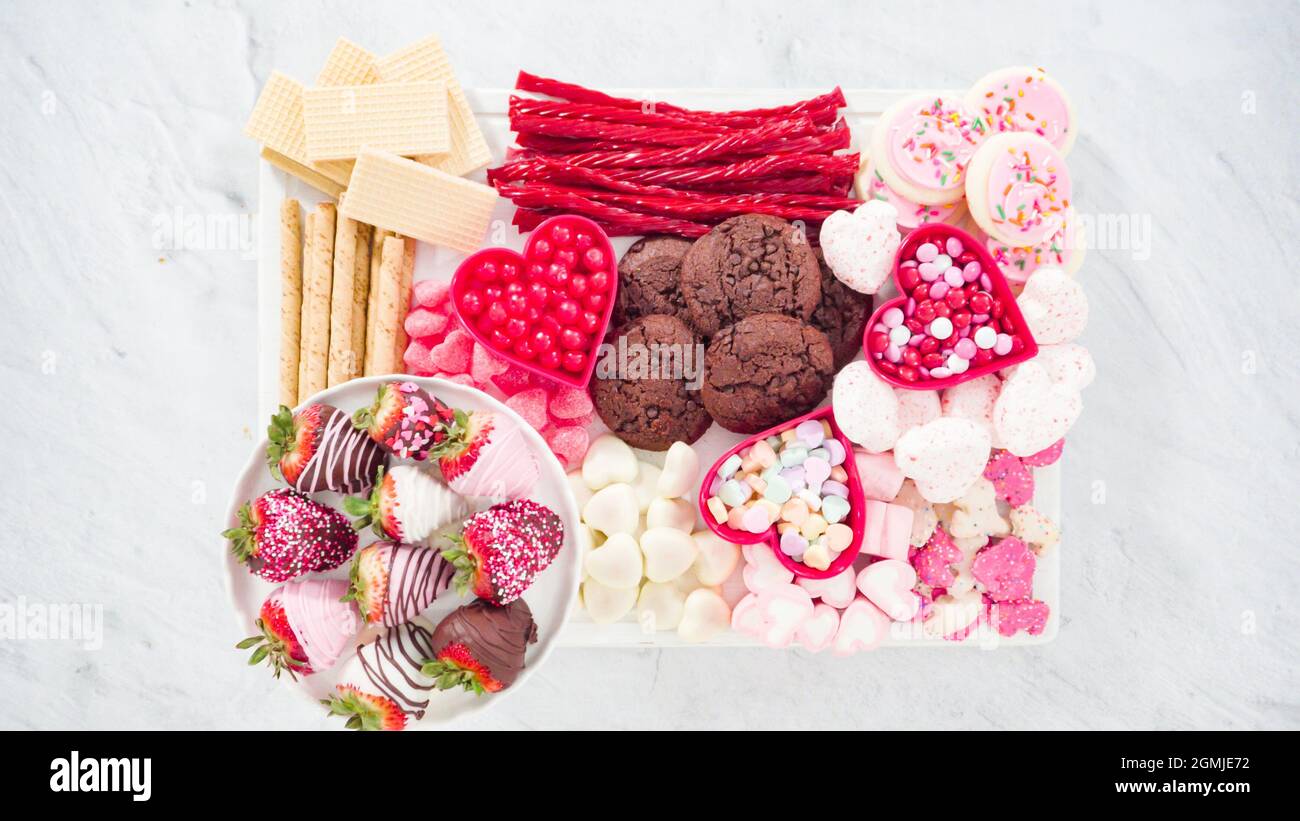 Flat lay. Step by step. Cheese board with candies and cookies for ...