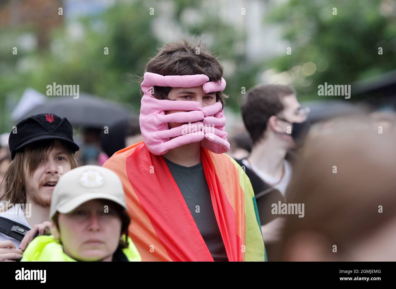 A participant wearing a mask takes part during the Equality March of ...