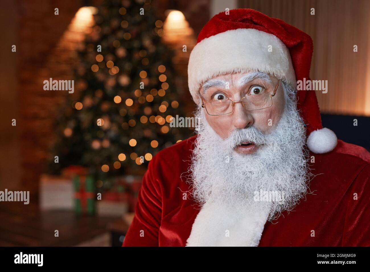 Portrait Of surprised Santa Claus in eyeglasses keeping mouth open in ...