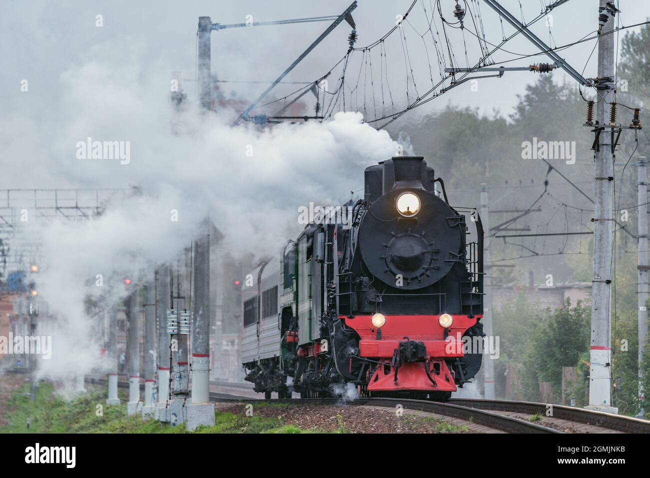 Steam retro train approaches to the station Stock Photo - Alamy