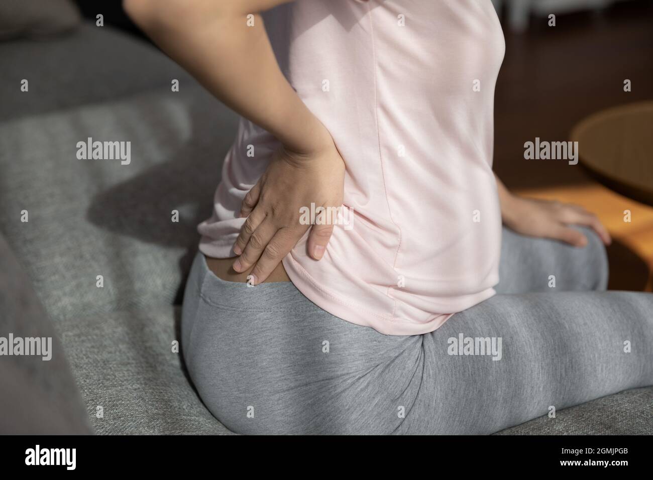 Expectant mother holding hand on back trying to reduce pain Stock Photo ...