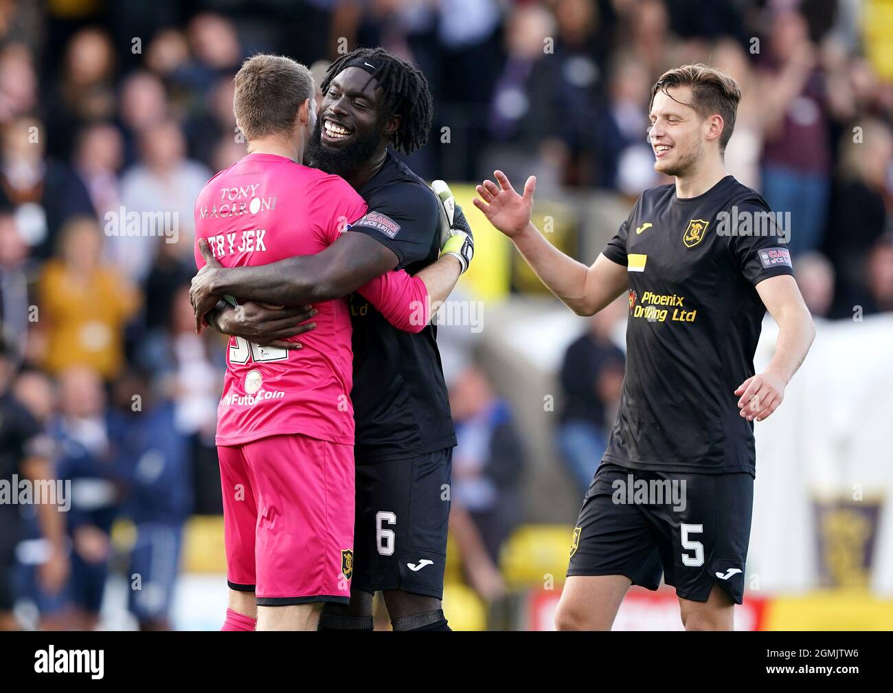 Livingston's Ayo Obileye (centre) celebrates with goalkeeper Max ...
