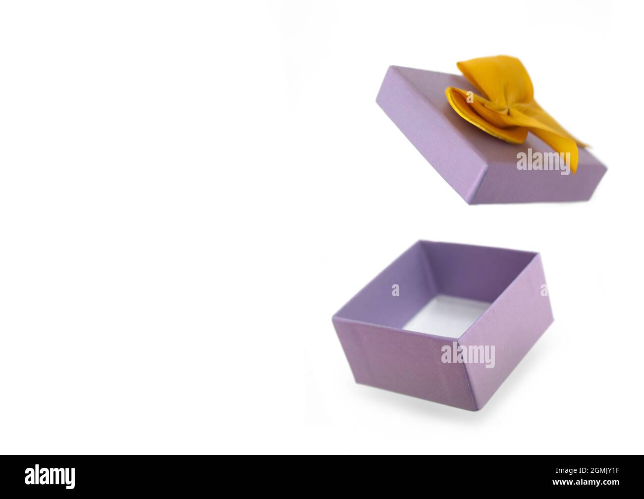 Blank open purple gift box with yellow ribbon bow isolated on white ...