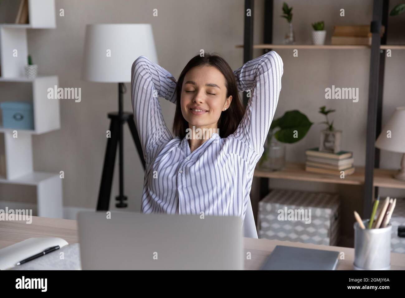 Peaceful calm woman relaxing at workplace after work done Stock Photo ...